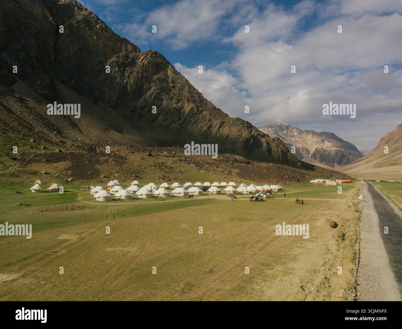 Aerial view of yurts scattered across a vast plain, nestled between ...