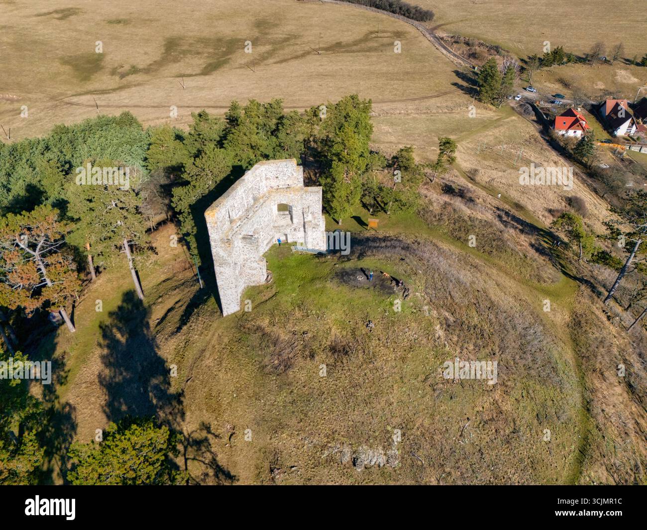 Aerial view of the stark stone ruins stand proudly atop a grassy knoll ...