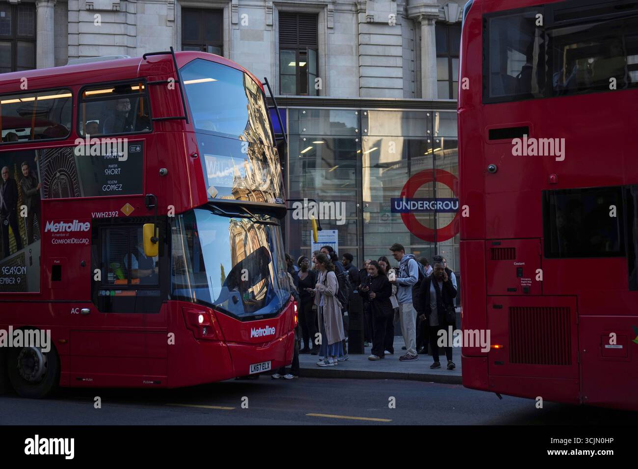 People queue for buses in London during a strike by members of the Rail ...