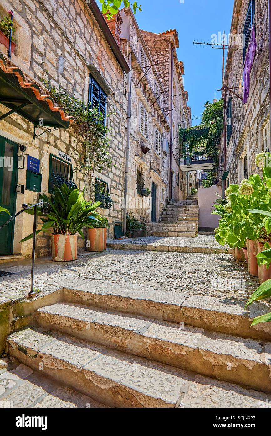 Rising stone steps in narrow alley walkways between old town buildings ...
