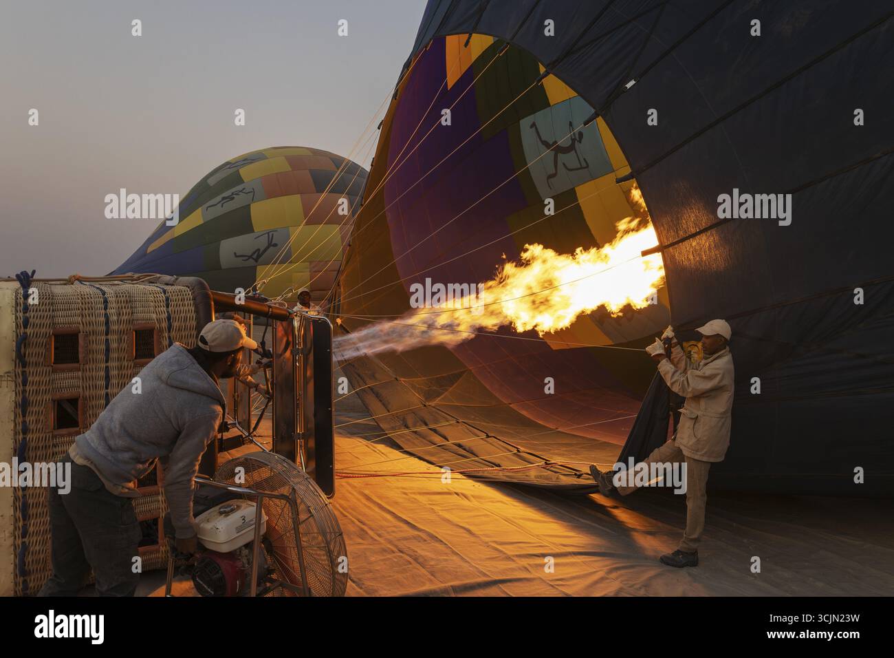 In order to get ready for the take-off, the pilot inflates the balloon ...
