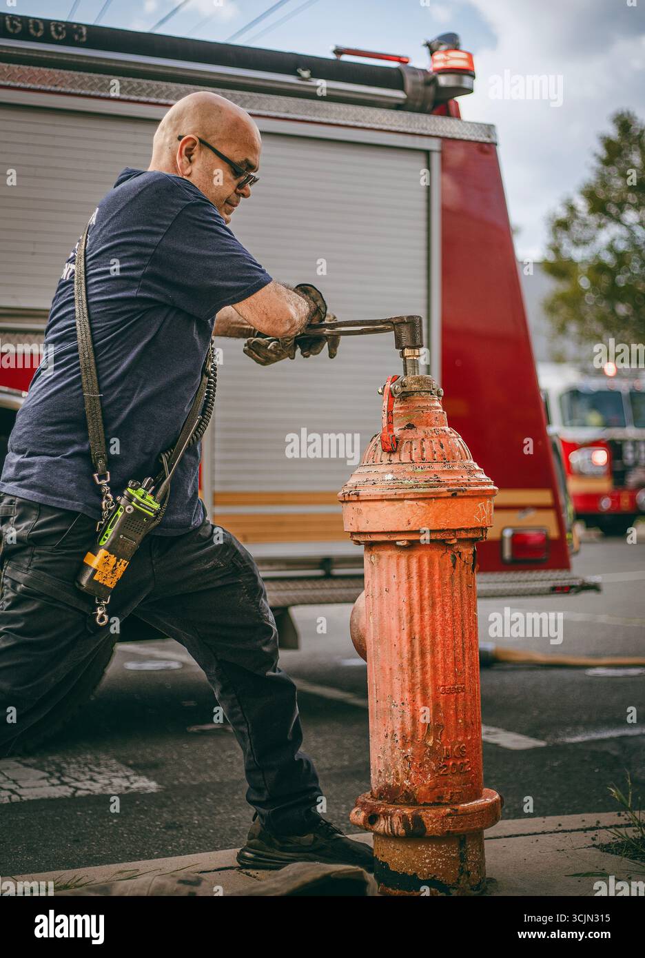 A firefighter opens a hydrant in Philadelphia Stock Photo - Alamy
