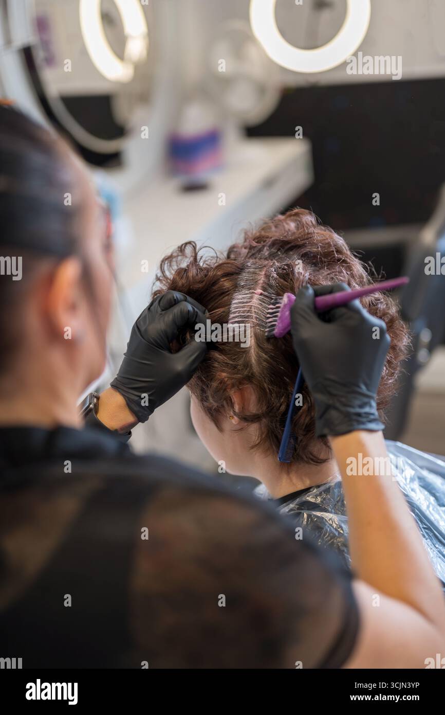 Teen age girl at salon, dyeing her hair, changing hair color Stock ...