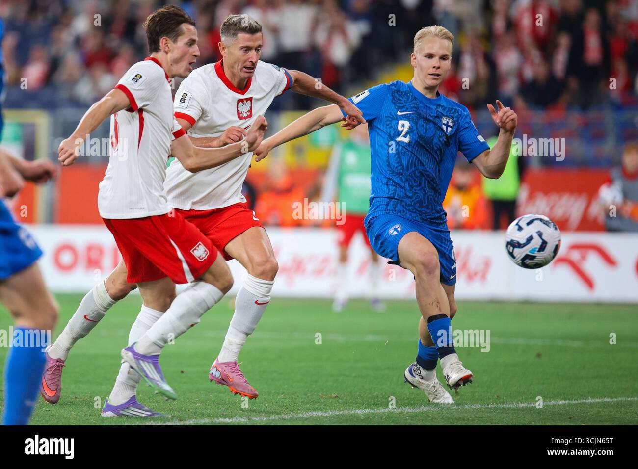 Jakub Kaminski (L), Robert Lewandowski (C) of Poland and Matti Peltola ...