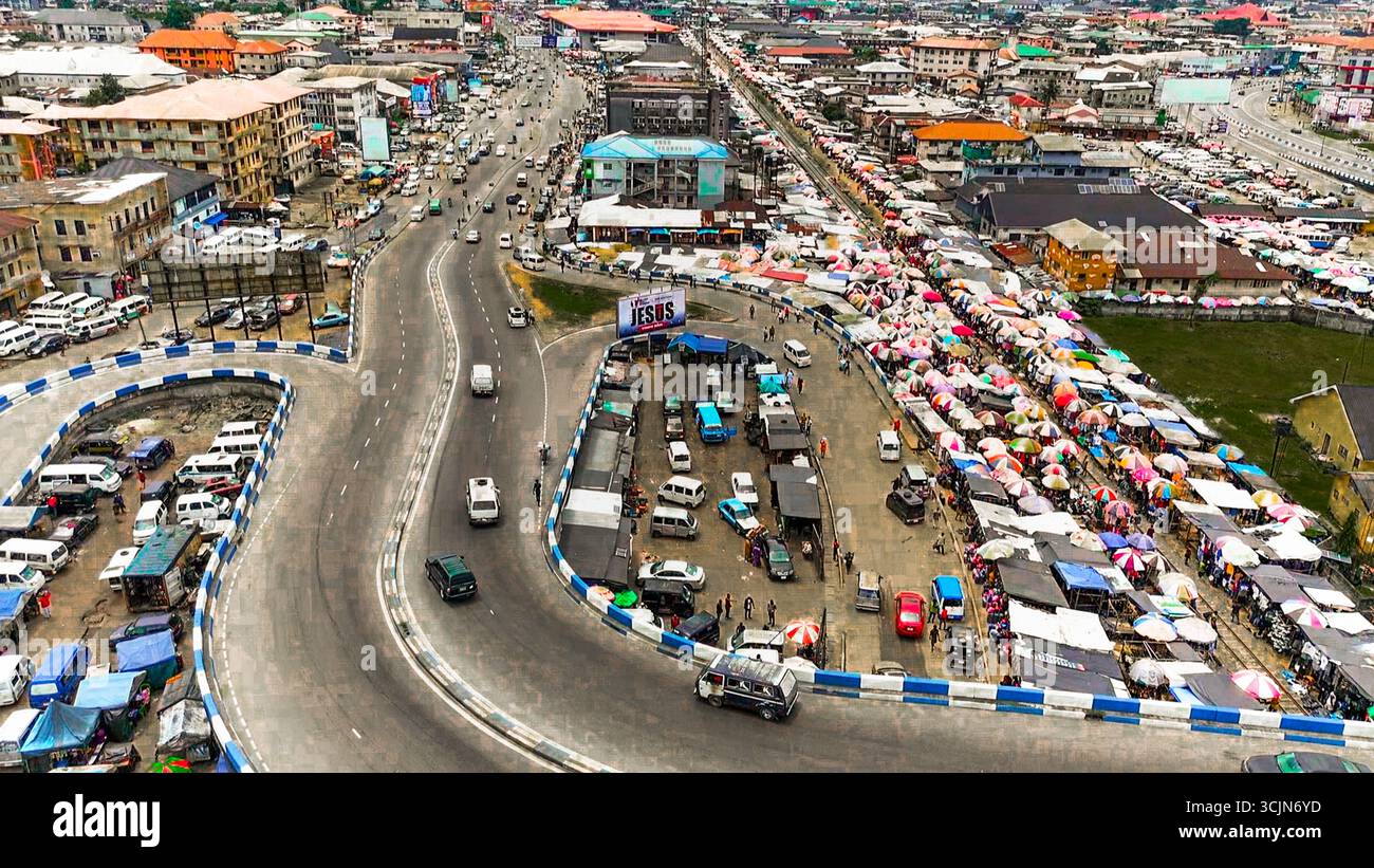 Aerial view of Isaac Boro Park bustling with cars and traders under ...
