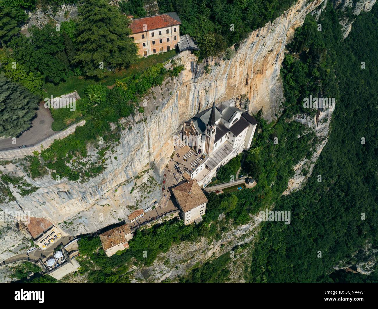 Aerial view of a church clinging to a sheer cliff face, a testament to ...