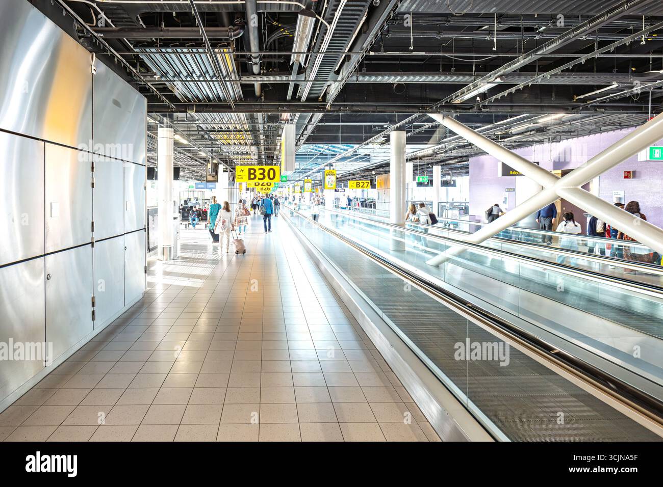 Amsterdam Schiphol Airport, Holland, August 25, 2025. Moving walkways ...