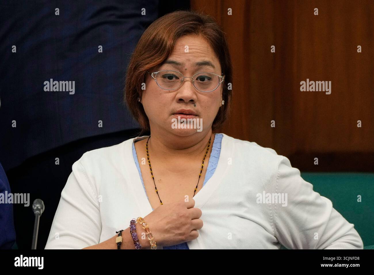 Private contractor Cezarah Discaya listens as she attends ...