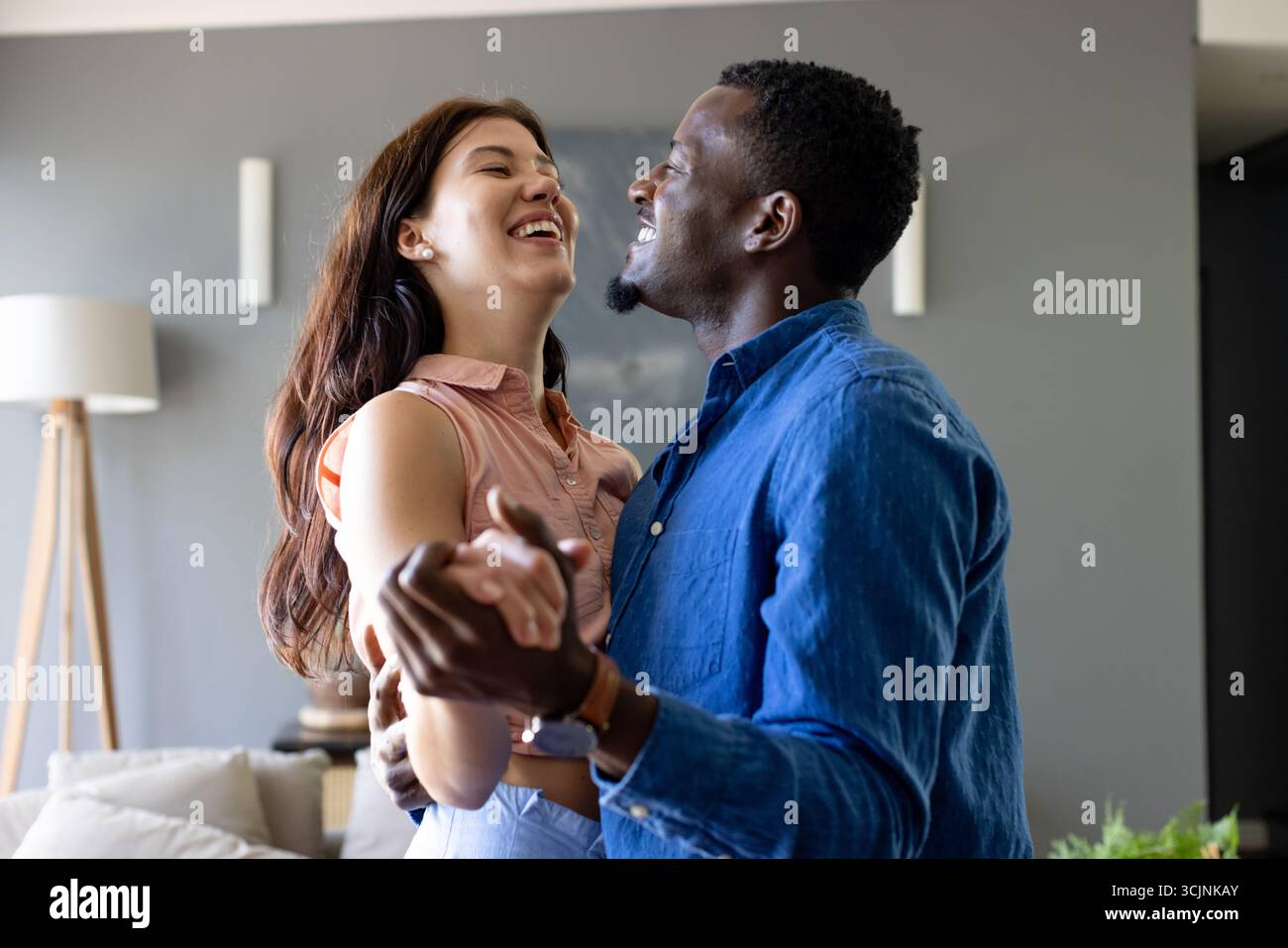Couple dancing joyfully at home, sharing happy and intimate moment ...