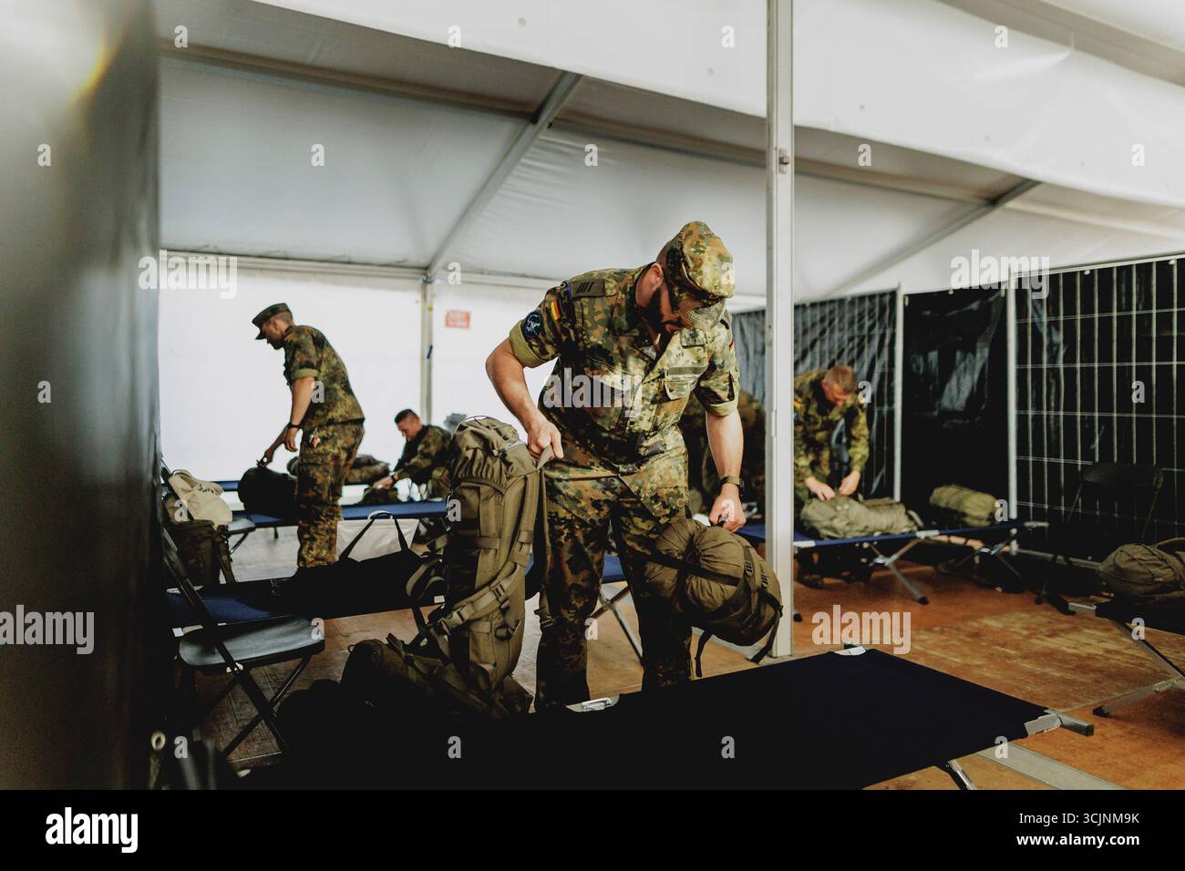 Soldiers move into a tented accommodation, pictured at the temporarily ...
