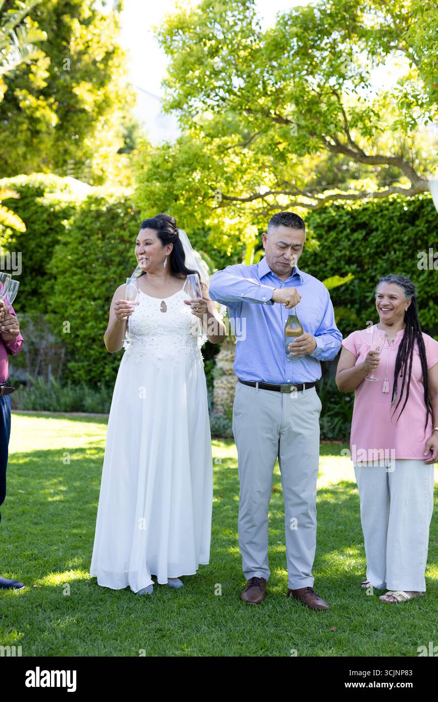 Celebrating outdoor senior wedding, senior couple with champagne ...