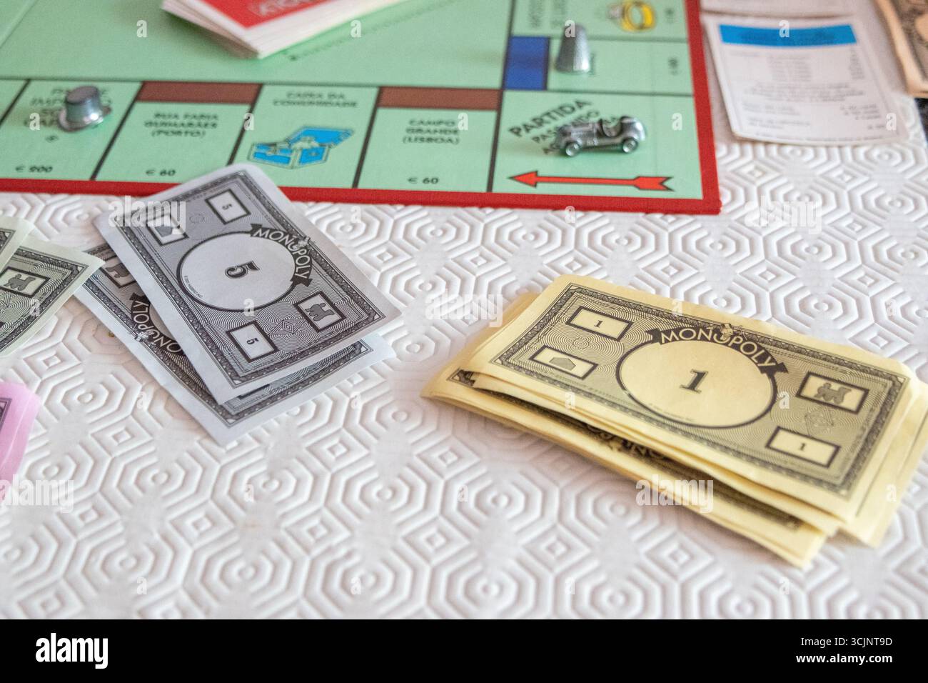 Monopoly money and board game illustrating financial and real estate ...