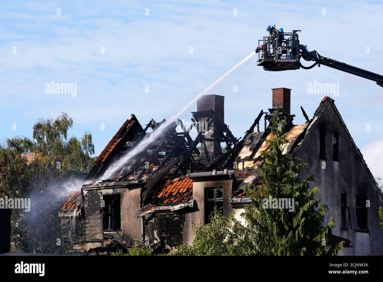 Firefighters extinguish a fire in a house, where four women aged 18-19 ...