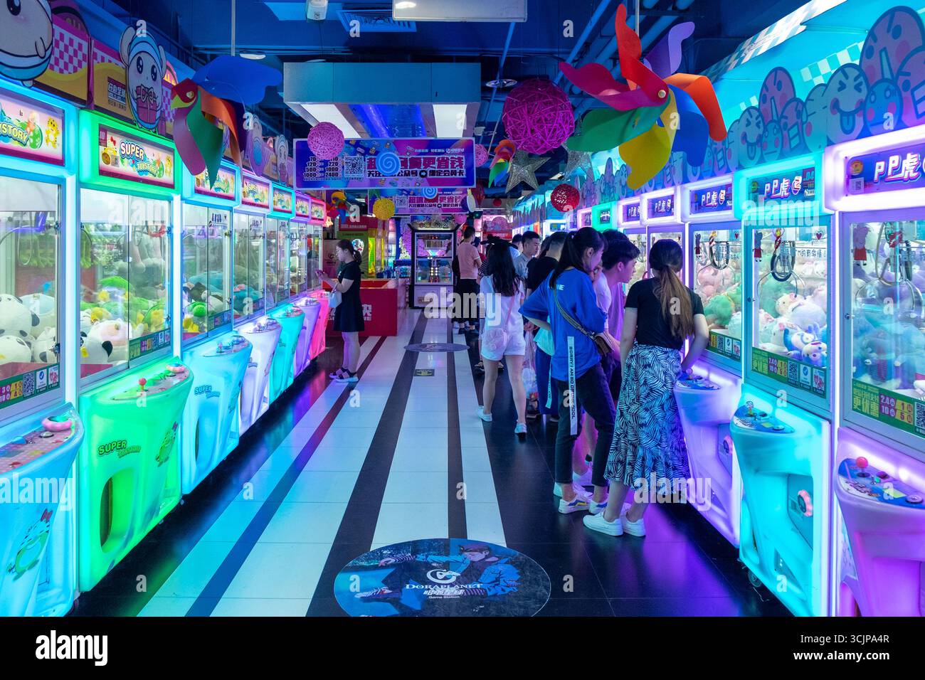 Brightly lit arcade with claw machines and neon lights in Chengdu ...