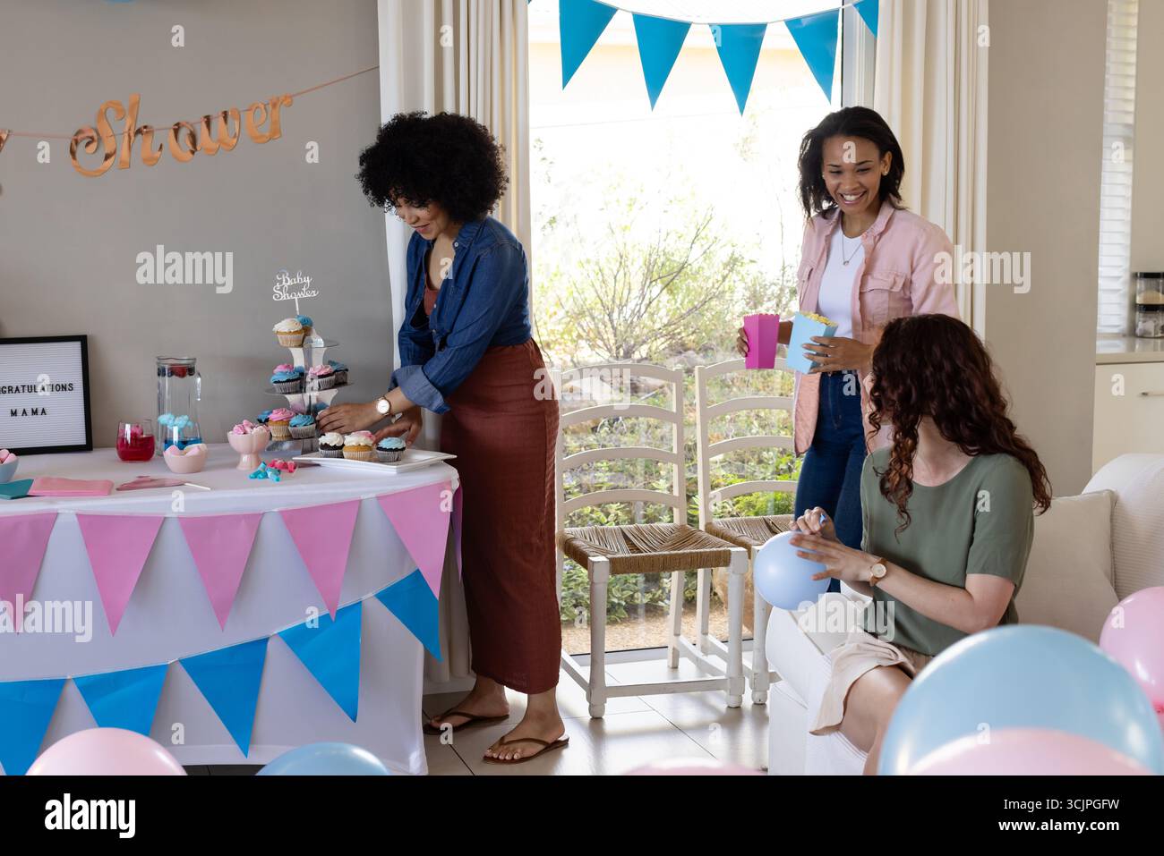 Women decorating baby shower hi-res stock photography and images - Alamy