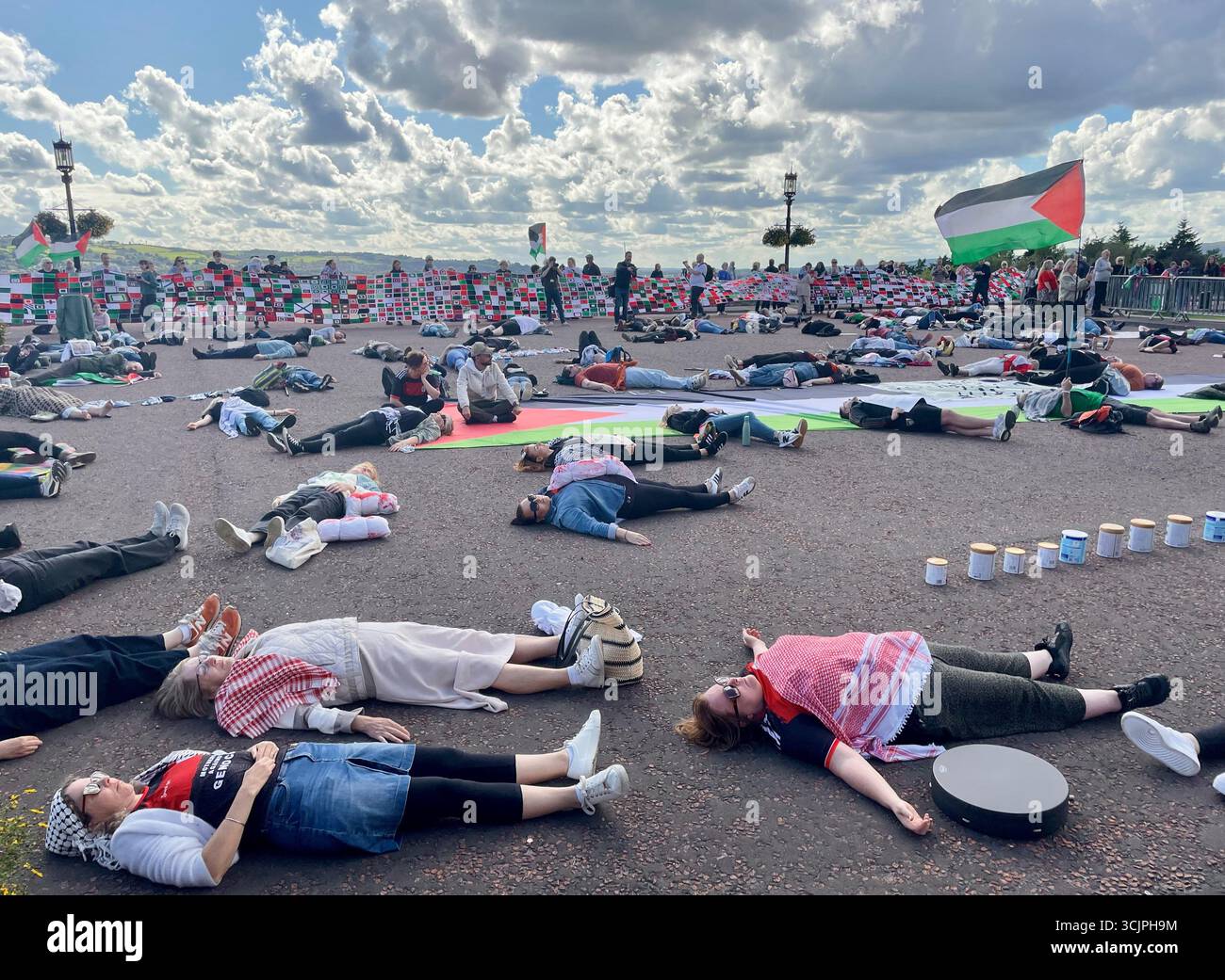 Campaigners from Mothers Against Genocide participate in a "die-in ...