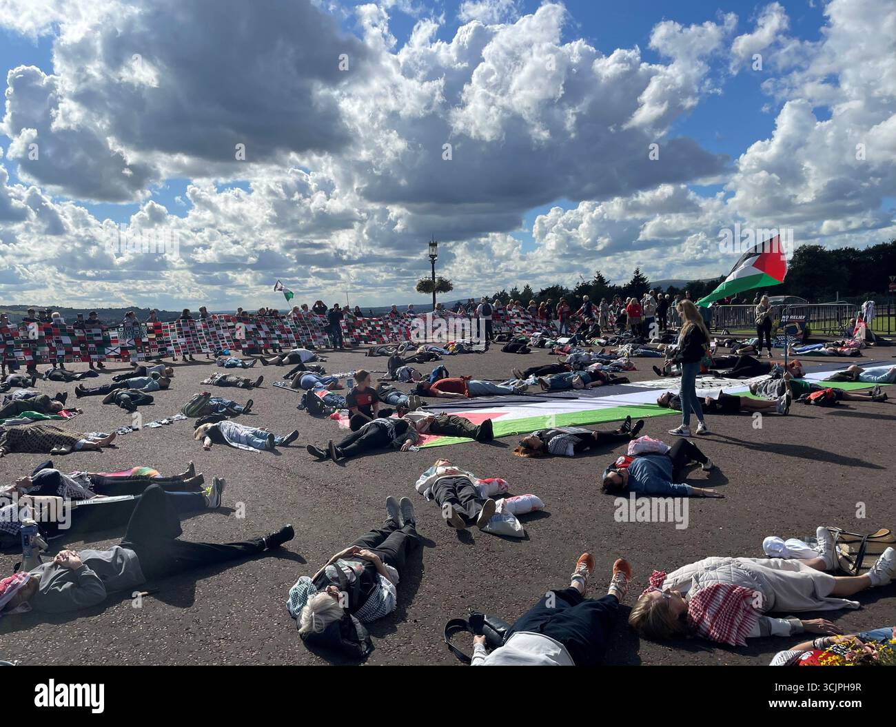 Campaigners from Mothers Against Genocide participate in a "die-in ...