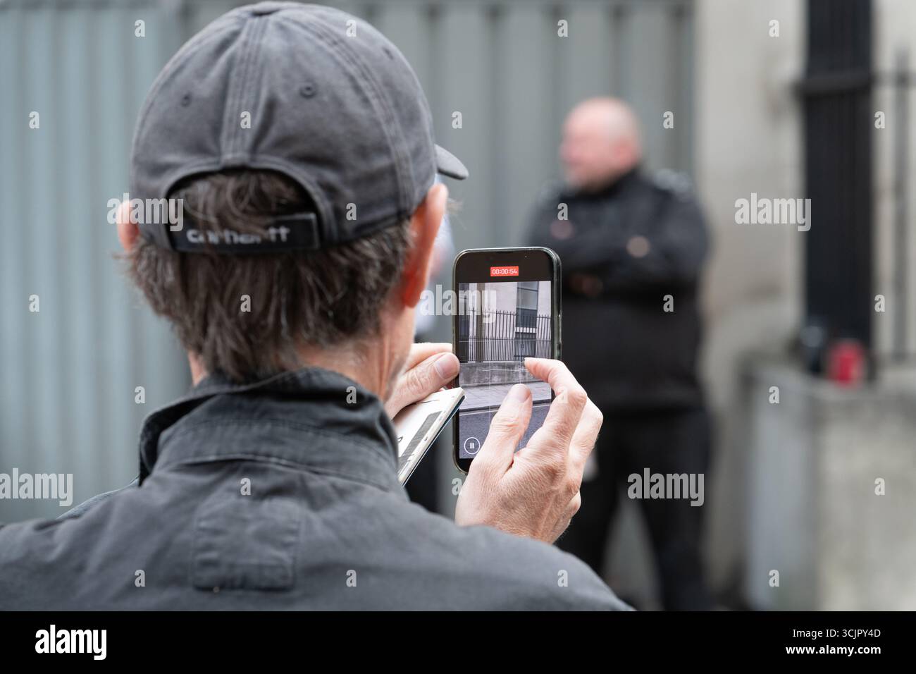 London, UK. 8 September, 2025. A man photographs the scene as security ...