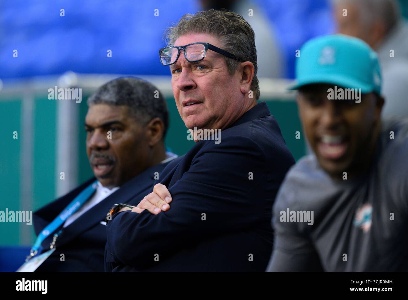 Dan Marino sits on the sidelines before an NFL football game between ...