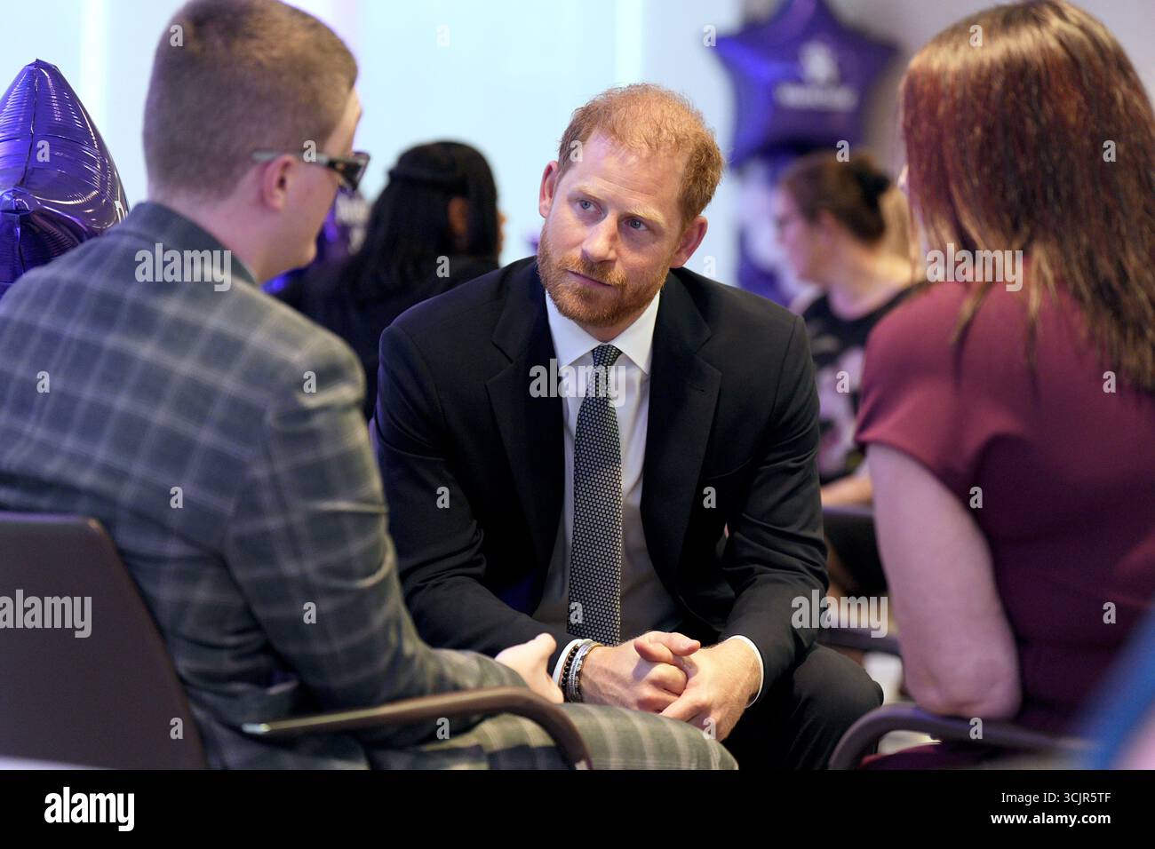 Britain's Prince Harry speaks with Declan Bitmead, left, recipient of ...