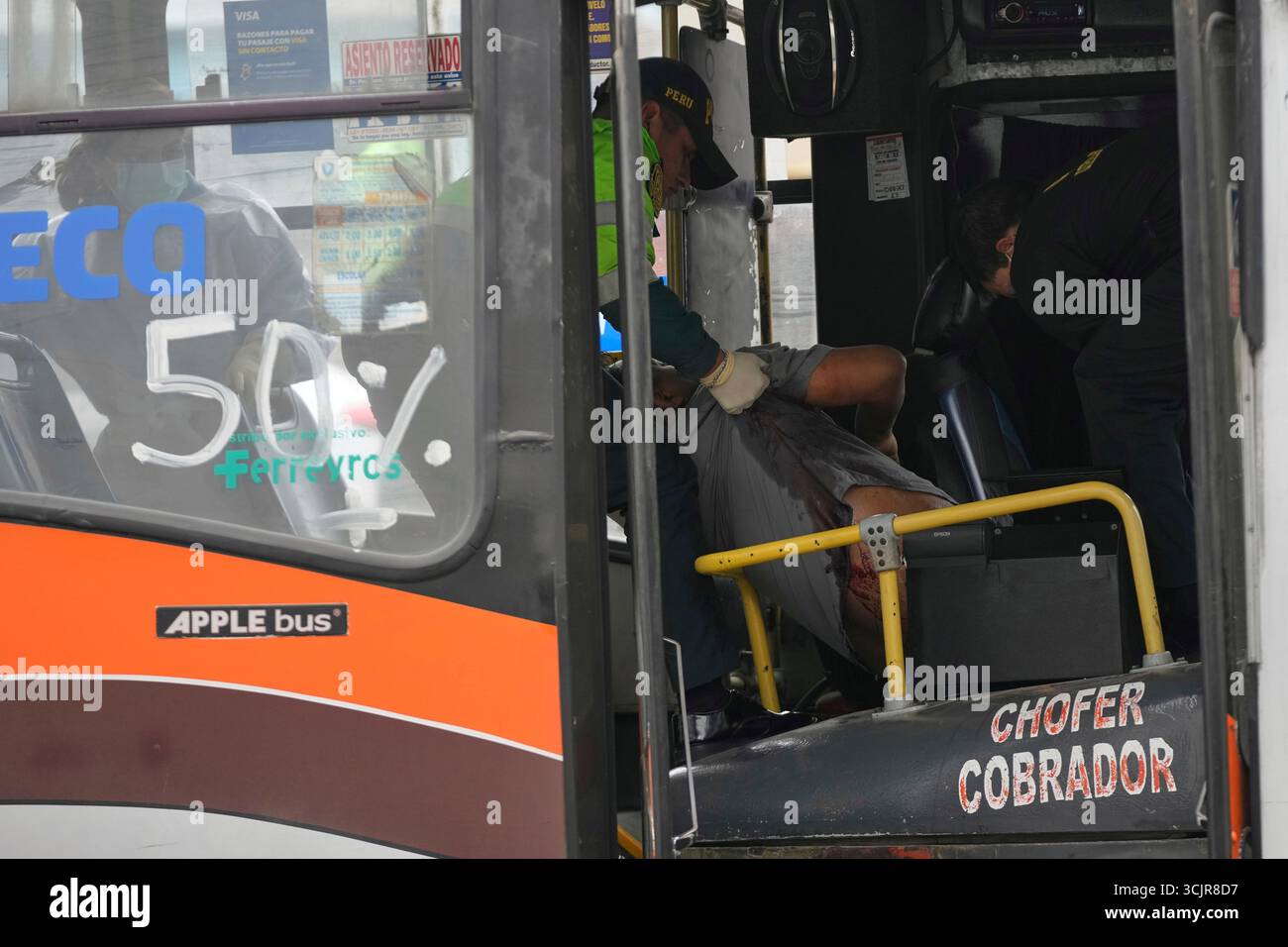 The body of bus driver Arturo Ramon is removed by police after he was ...
