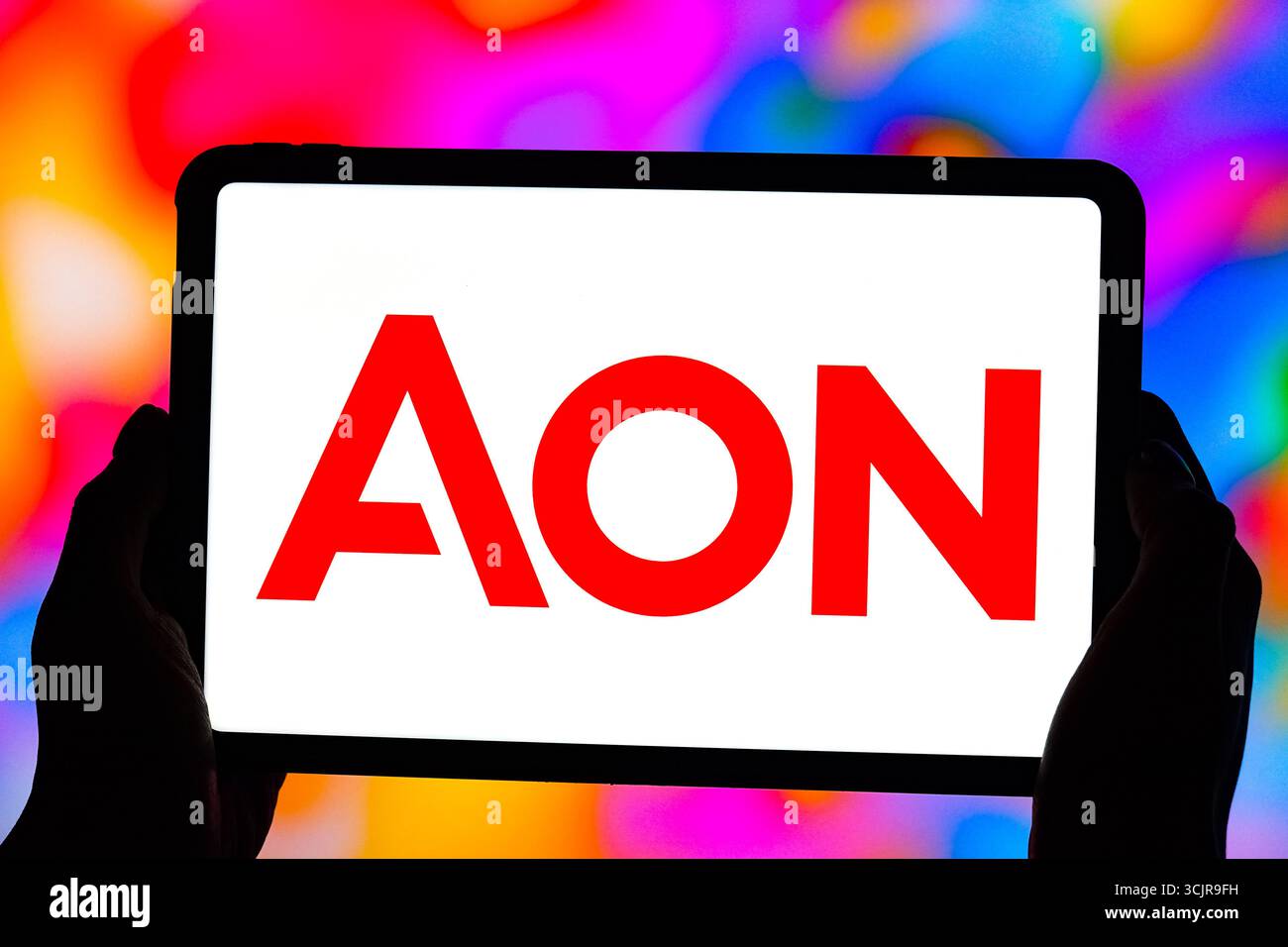 In this photo illustration, the logo of Aon is seen displayed on the ...