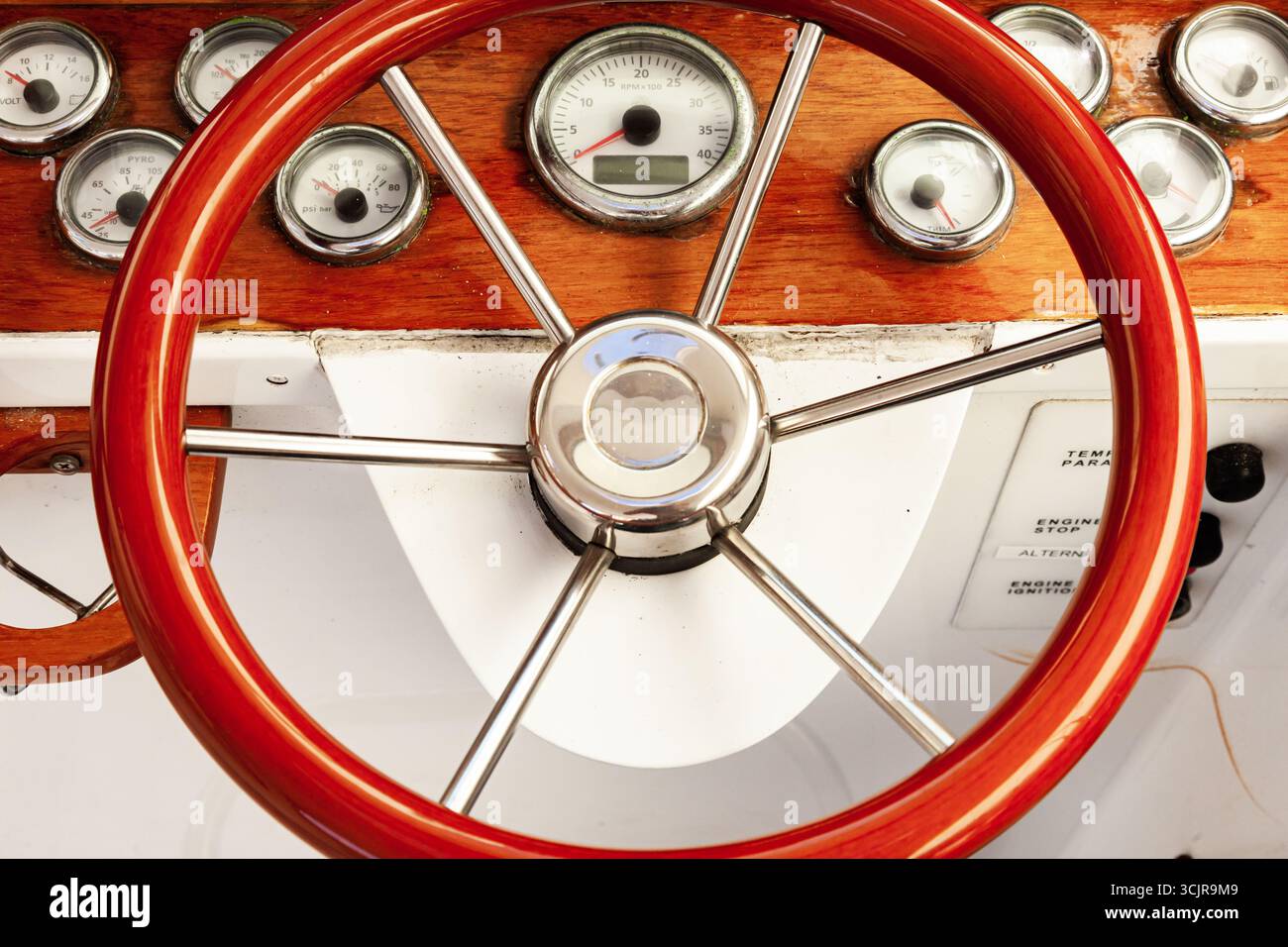 The cockpit of a luxury yacht with a classic, circular steering wheel ...