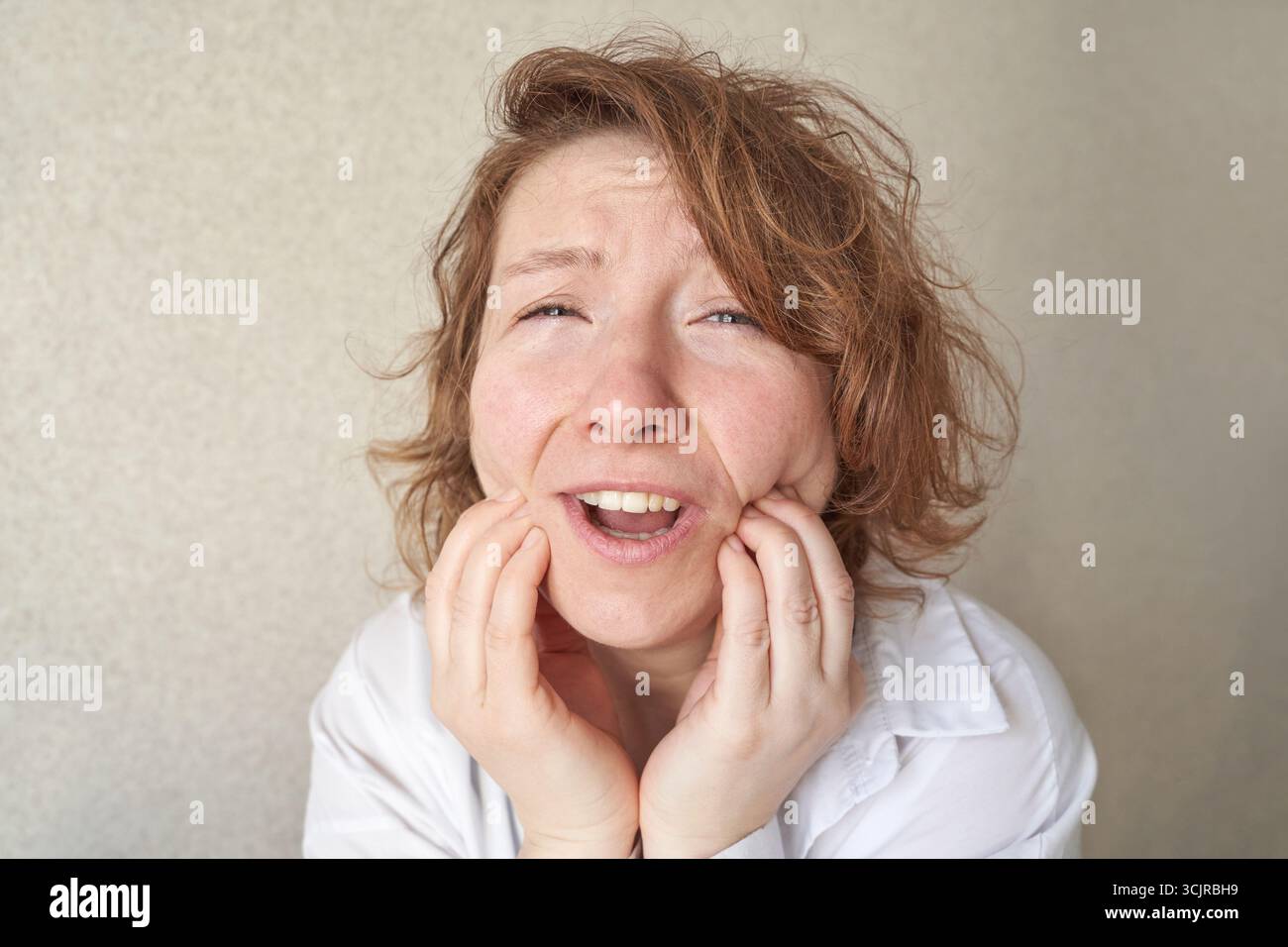 Female caucasian adult expressing desperation with hands on face ...