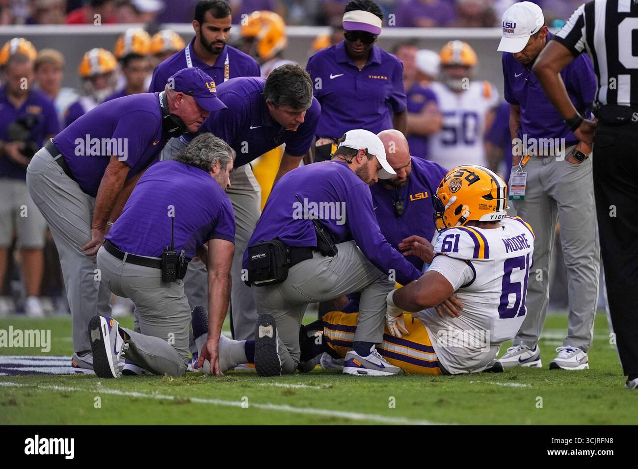 FILE - LSU offensive lineman Braelin Moore (61) is helped up after ...