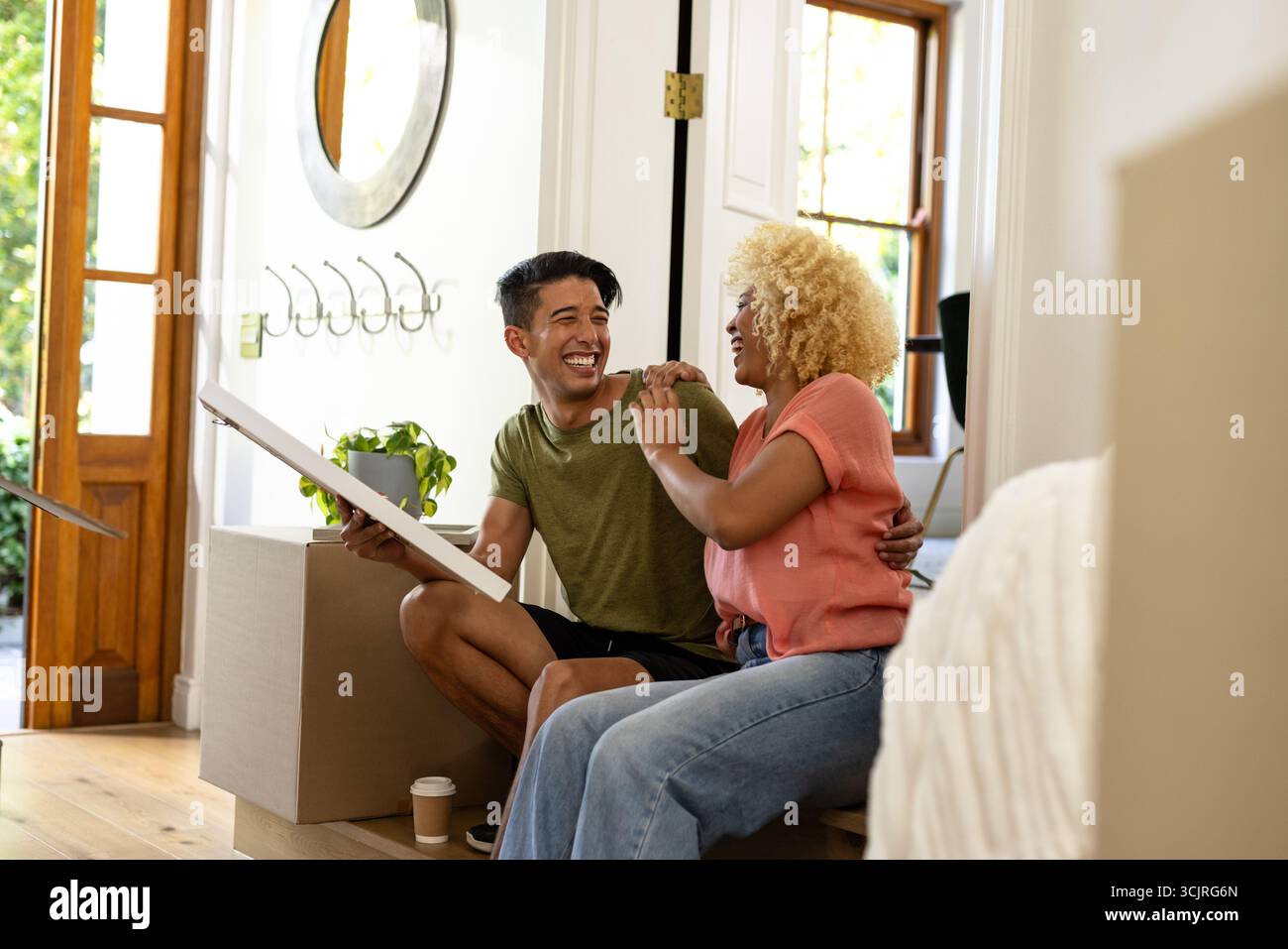 Laughing diverse couple unpacking hi-res stock photography and images ...