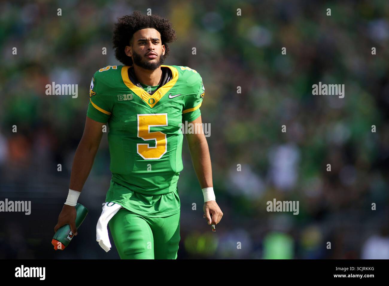 Oregon quarterback Dante Moore (5) walks on the field during a break in ...