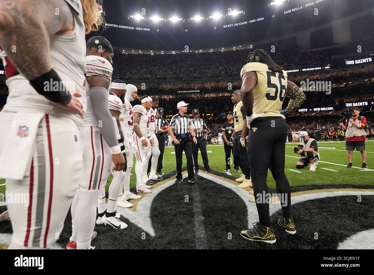 The head referee performs the coin toss before an NFL football game ...