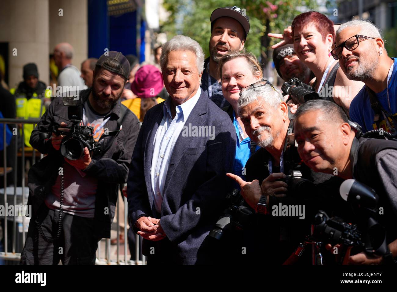 Dustin Hoffman poses with photographers at the premiere of "Tuner" at ...