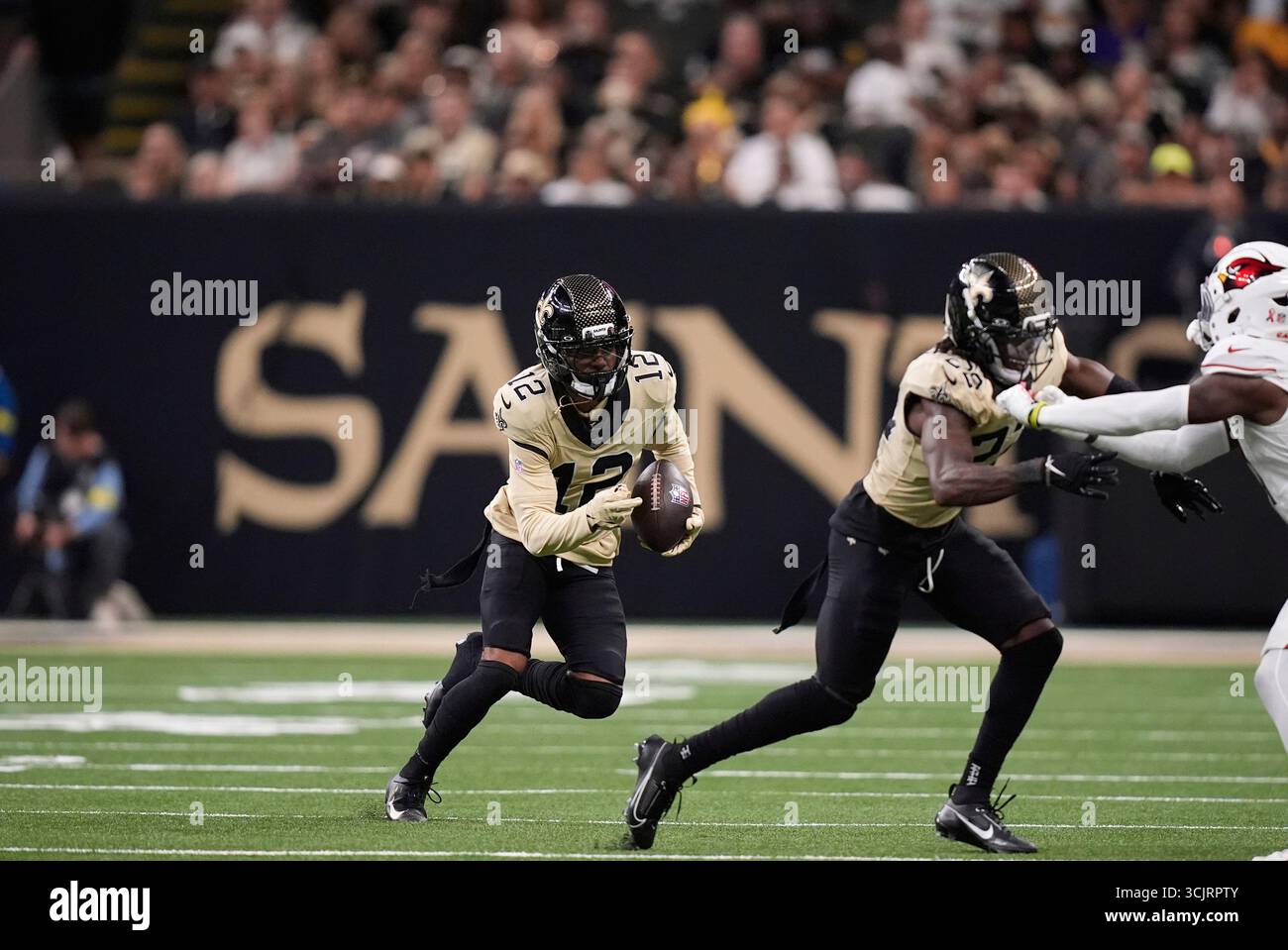 New Orleans Saints wide receiver Chris Olave (12) carries against the ...