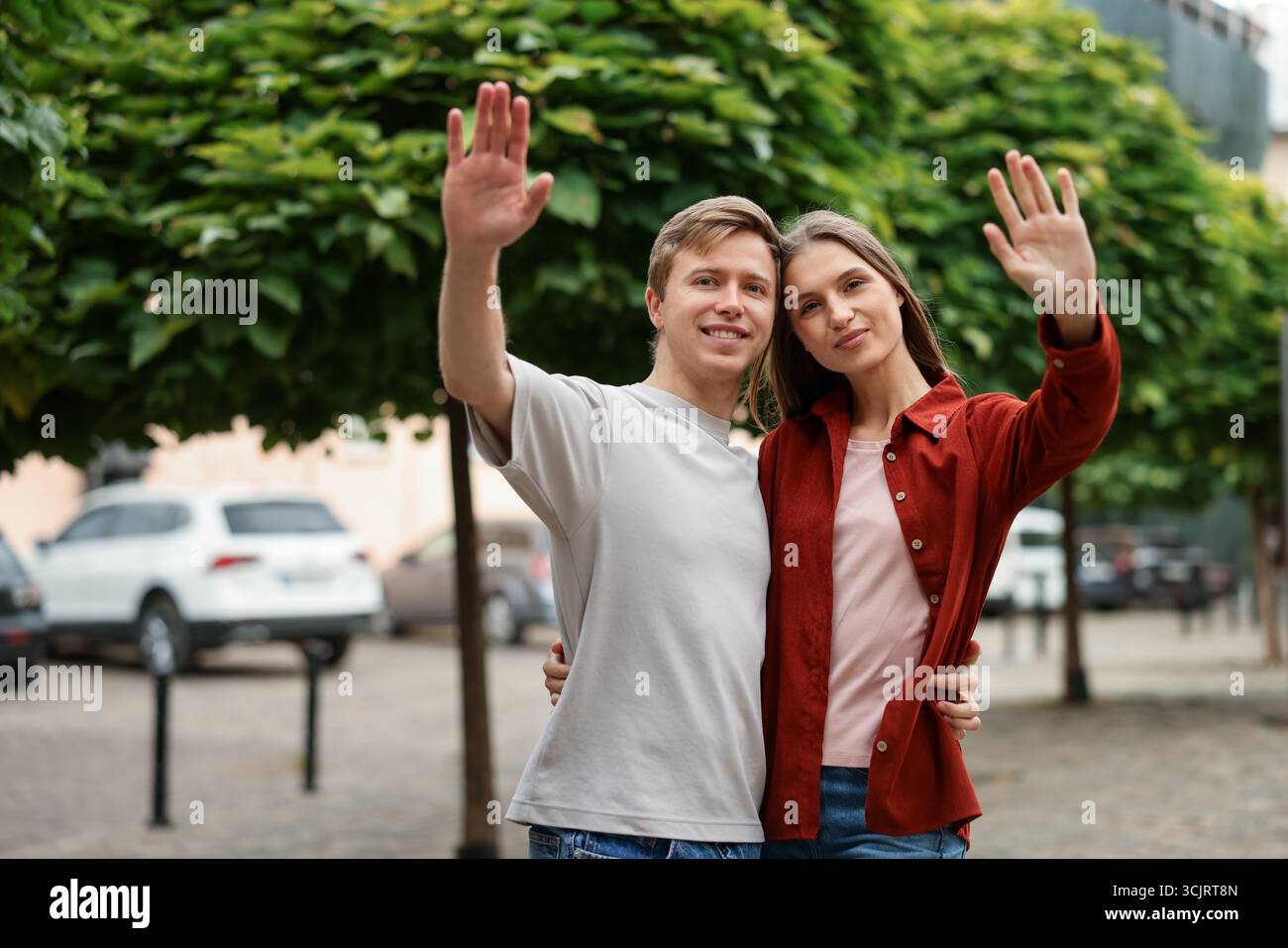 Goodbye. Lovely couple waving on city street, space for text Stock ...