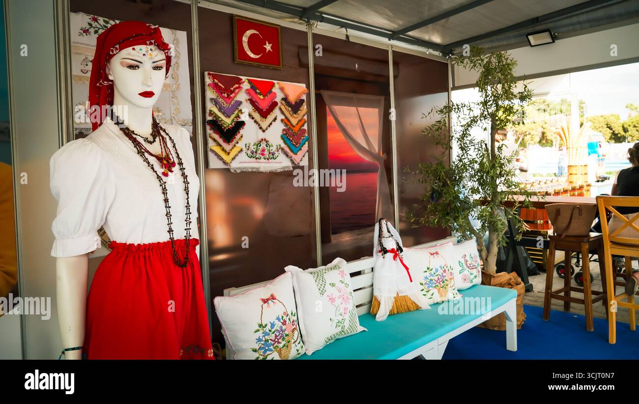 A mannequin with a red headscarf, white blouse, and traditional jewelry ...