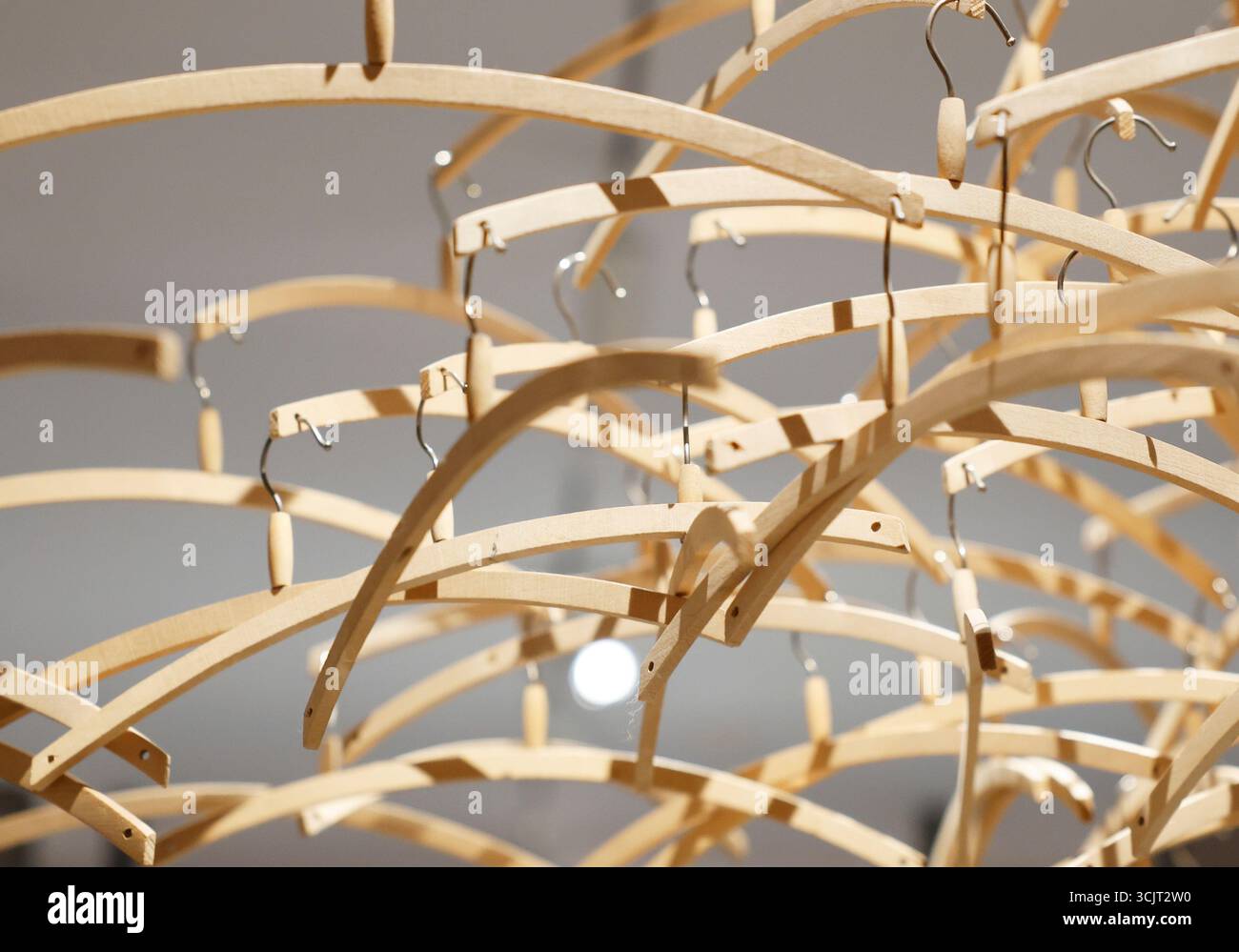 Sixty three wooden coat hangers titled "Obstruction" is on display at a ...