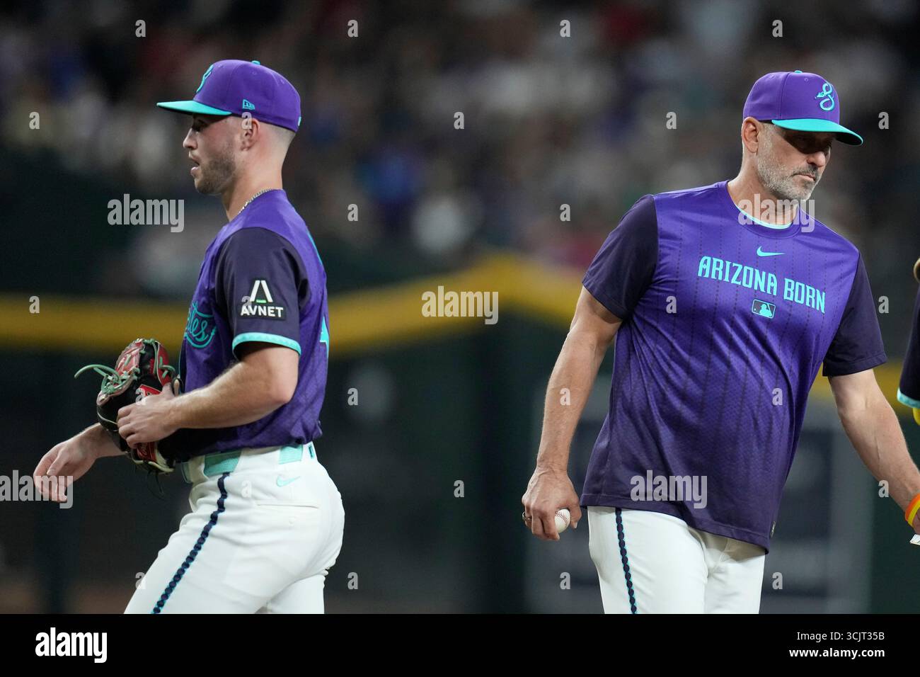 Arizona Diamondbacks manager Torey Lovullo, right, takes the ball from ...