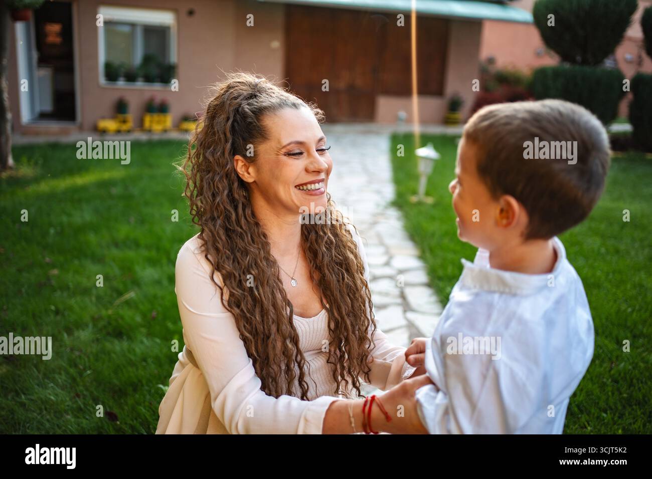 Joyful connection between mother and son in the garden Stock Photo - Alamy