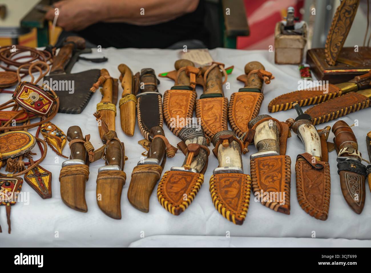 Collection of handmade knives with carved wooden handles and decorated ...