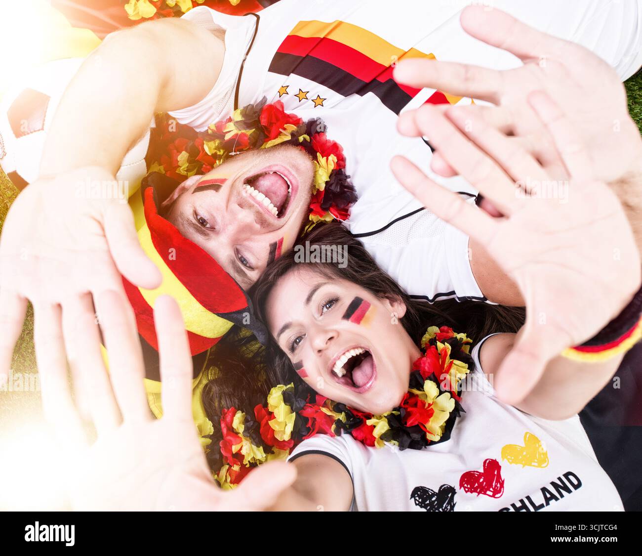 made-up cheering couple at a football championship Stock Photo - Alamy