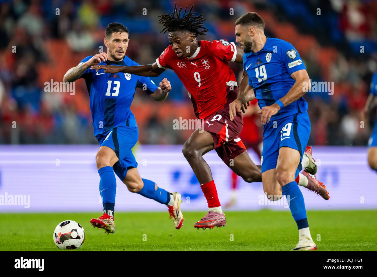 Switzerland's Johan Manzambi, center, fights for the ball against ...