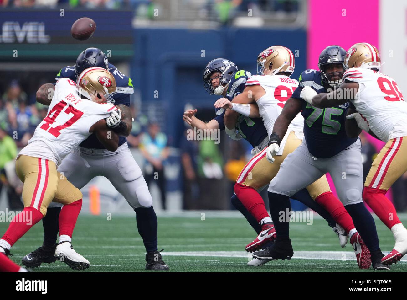 Seattle Seahawks quarterback Sam Darnold (14) is tackled by San ...
