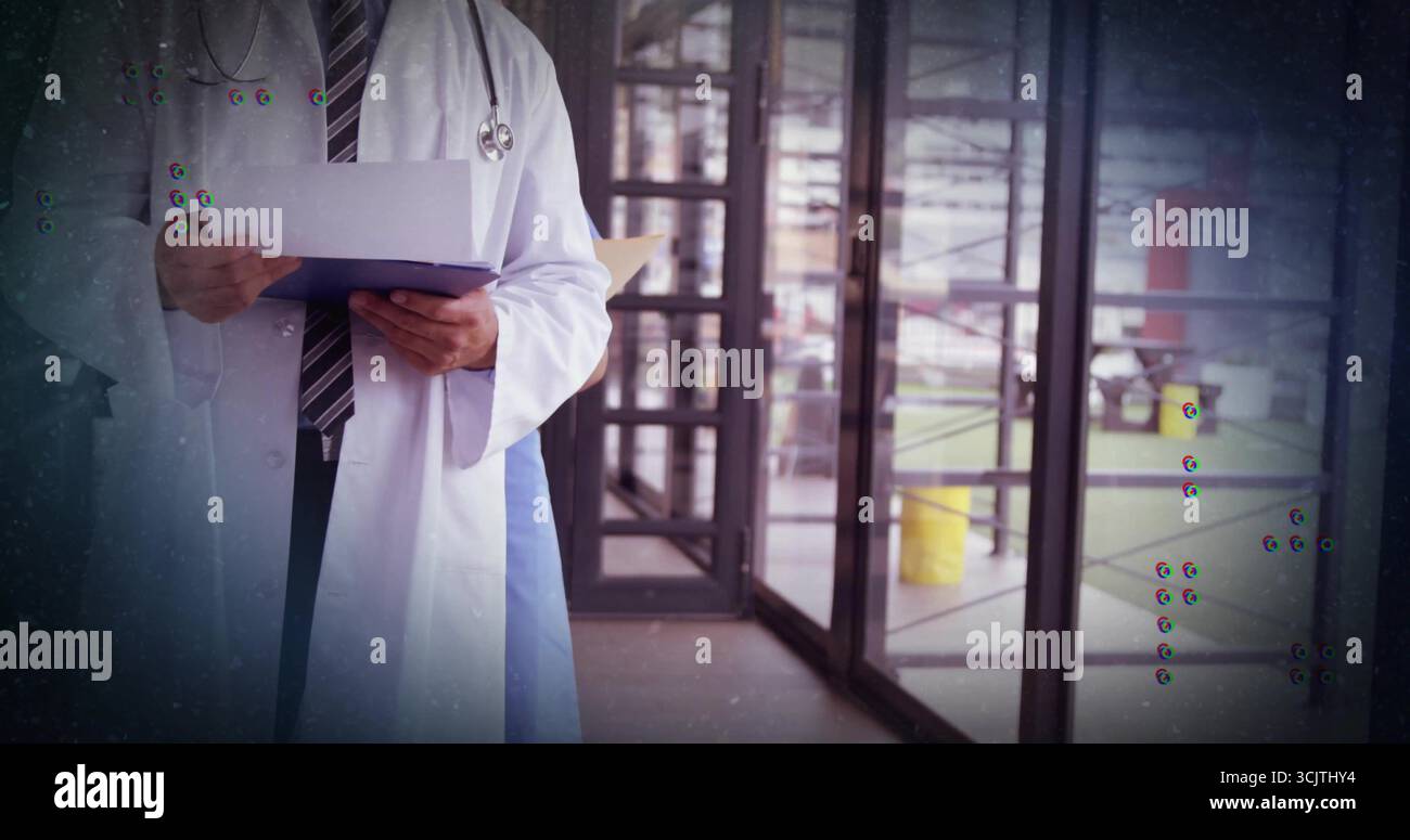 Standing doctor holding folder, stethoscope by framed glass doors ...