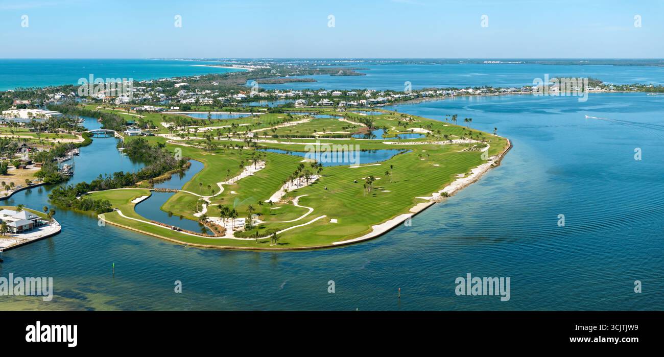 Big golf course field with green grass in Boca Grande, small town on ...