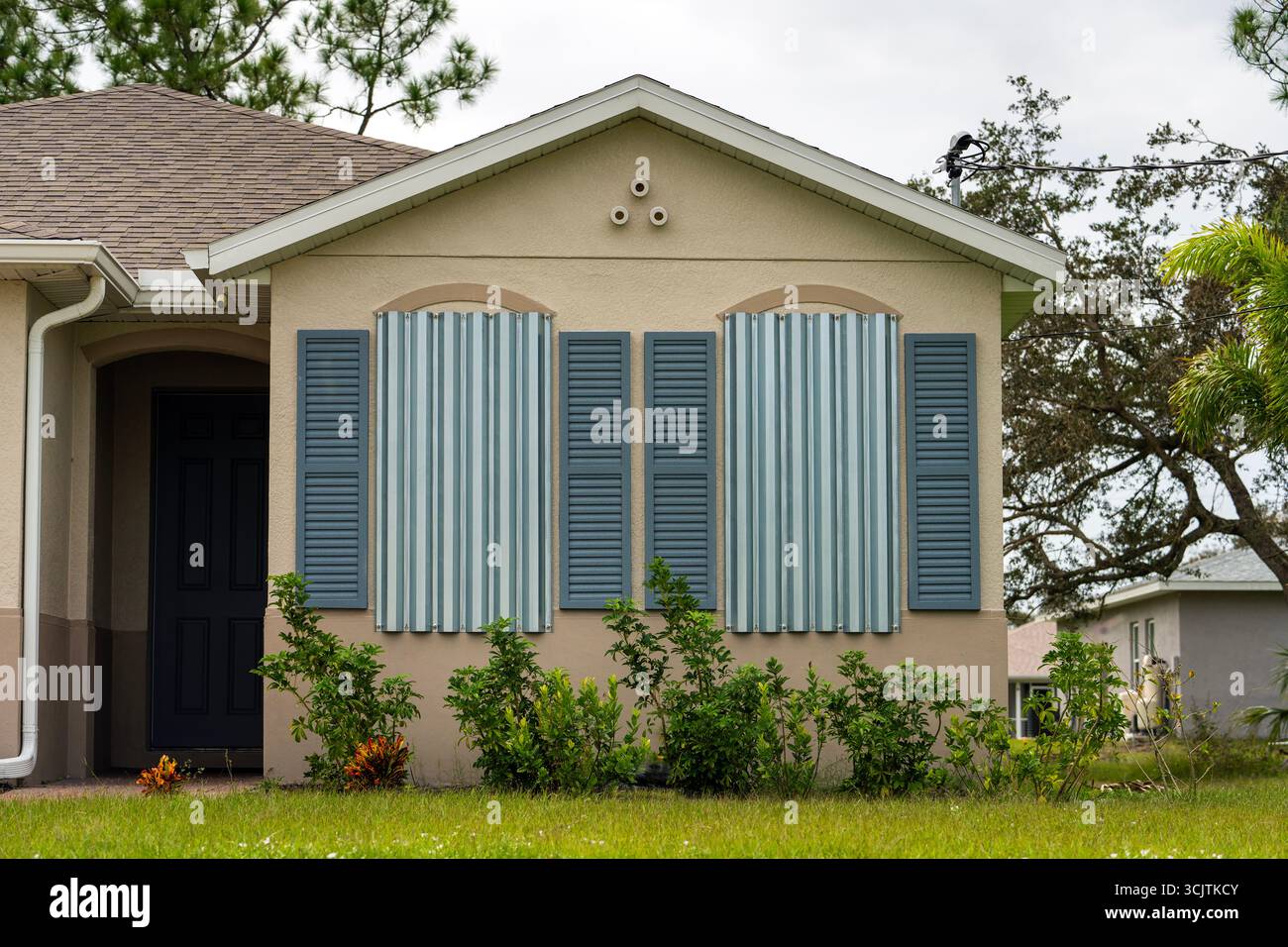 Florida home with hurricane shutters secured over windows for storm ...