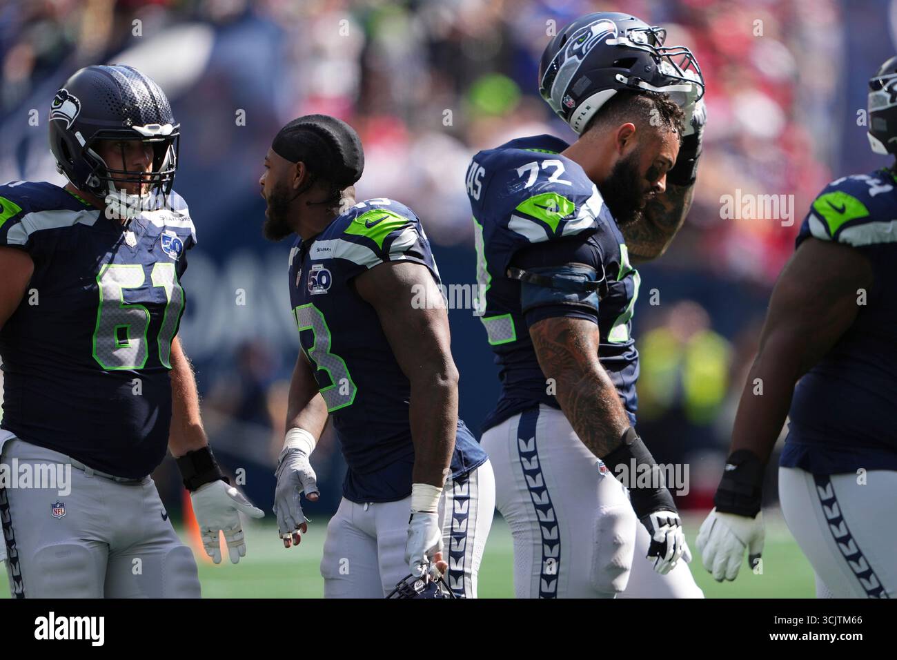 Seattle Seahawks linebacker Ernest Jones IV (13) greets center Jalen ...