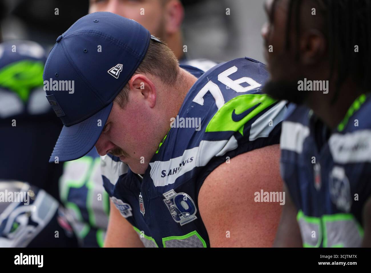 Seattle Seahawks guard Grey Zabel looks down on the bench during an NFL ...