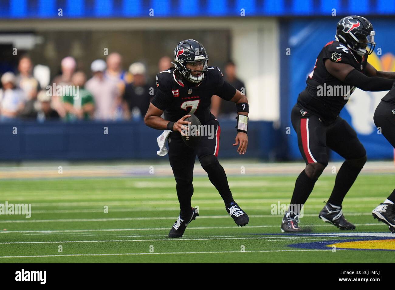 Houston Texans quarterback C.J. Stroud (7) scrambles with the ball of ...