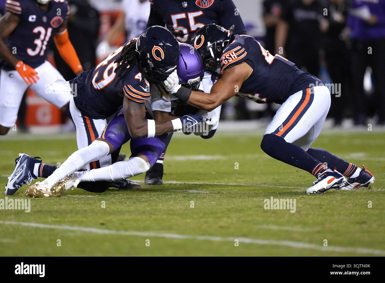 Minnesota Vikings wide receiver Justin Jefferson, center, is tackled by ...